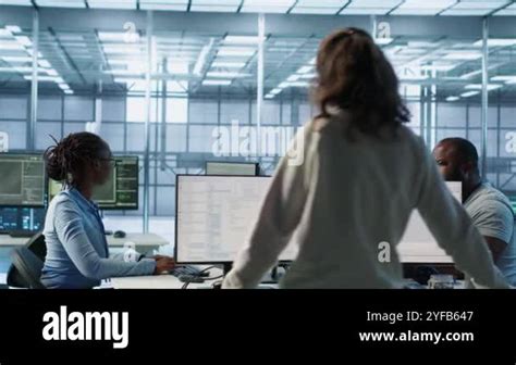 Admin Arriving In Server Hub Sitting At Computer Desk Checking