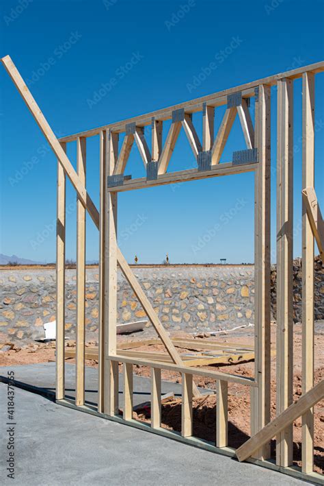 A Prefab Wall Section Is In Place On A New Home Construction Project