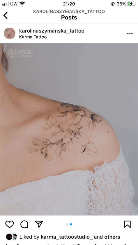 The Back Of A Womans Shoulder With Flowers Tattooed On Her Left Arm