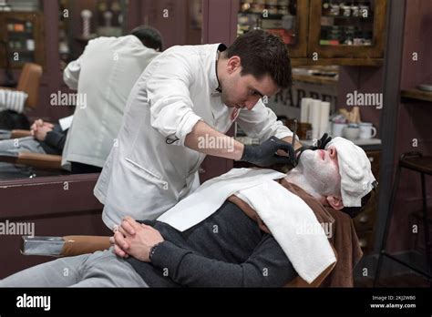 Irelanddublin Barber Giving A Straight Razor Shave To A Customer