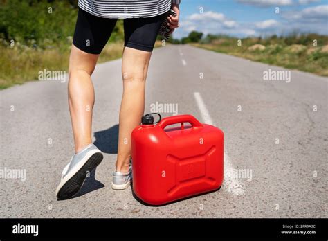 A Car Parked On The Side Of The Road An Empty Red Canister The Girl