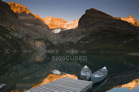 Canoes Moored By Pier On Lake OHara At Sunset British Columbia Canada