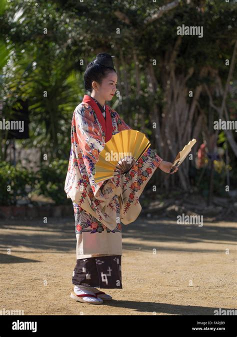 Okinawan Woman In Traditional Costume Performing Fan Dance Ryukyu Mura