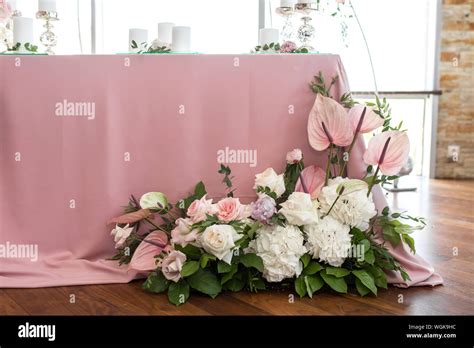 The Wedding Table Setting For The Newlyweds Is Decorated With Fresh Flowers Of Carnation Rose