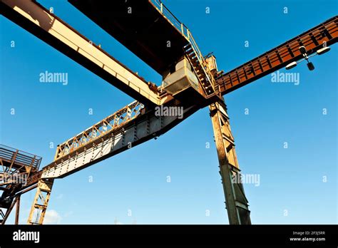 View Of A Rusted And Disused Gantry Crane Against A Clear Blue Sky At