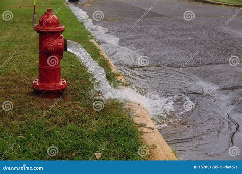 Open Fire Hydrant Water Flowing From Open Fire Hydrant On Street And