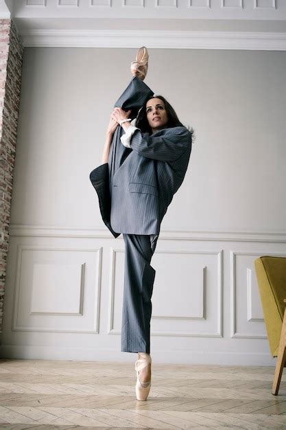 Premium Photo Ballerina In A Gray Striped Suit And Pointe Shoes