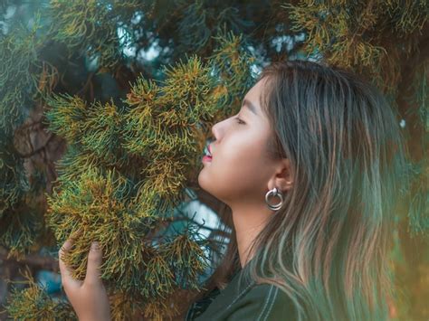 Premium Photo Portrait Of Girl Looking At Tree