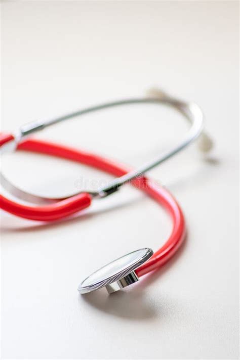 Red Stethoscope In Doctors Office For Professional Cardio Checkup And Healthy Heartbeat Pulse