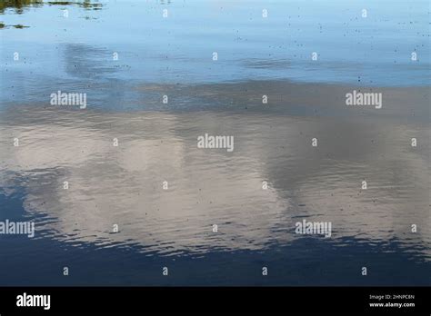 Detailed Close Up View On Water Surfaces With Waves And Ripples And The Sunlight Reflecting At