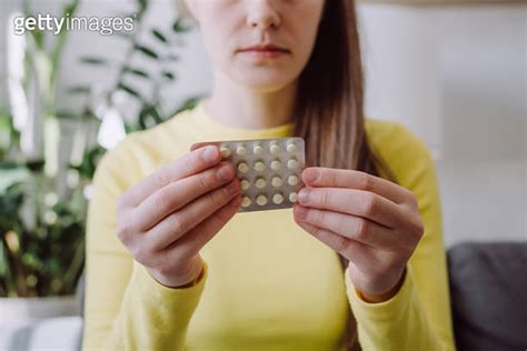 Selective Focus Of Young Girl Hands Holding Hormonal Oral Contraceptive