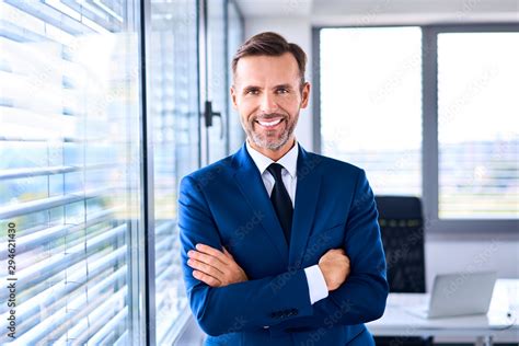 Portrait Of Successful Businessman Standing In Corner Office Stock Photo Adobe Stock