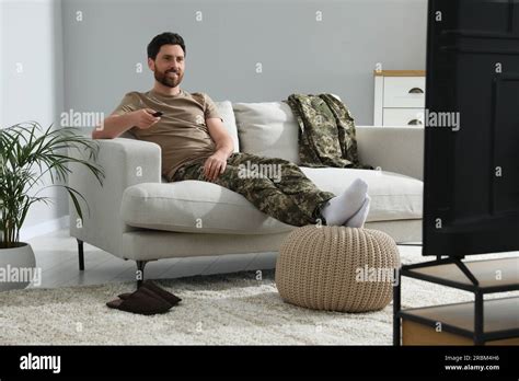 Happy Soldier Watching Tv On Sofa In Living Room Military Service
