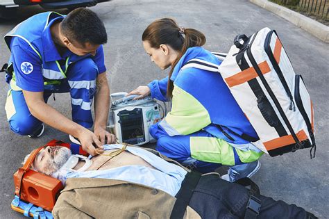 Paramedics Treating Patient Stock Image F0375050 Science Photo