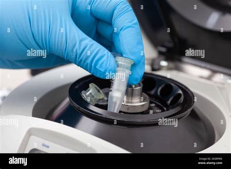 Closeup Of A Scientist Hand Placing A Tube Into An Small Table