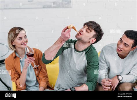 Handsome Young Man Eating Pizza Sitting While Multicultural Friends