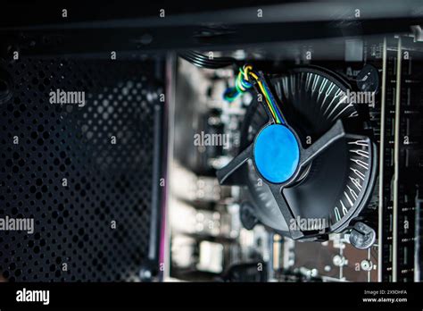 Close Up View Of A Computer Cpu Cooler With A Blue Fan Inside A Desktop Case The Image Shows