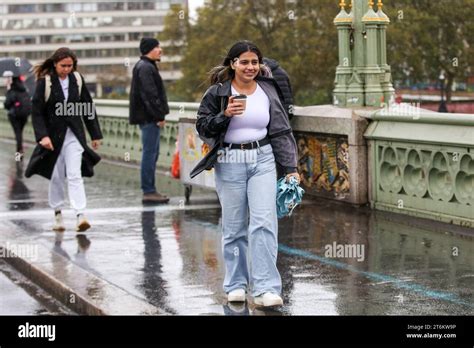 A Woman Is Caught In The Rain In Central London Weather Forecasters