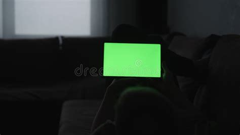 Man At Home Lying On A Couch With Tablet Pc With Green Screen Stock