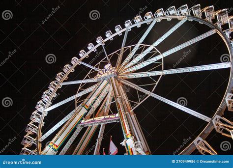 A Low Angle Shot Of A White Ferris Wheel At Night Stock Photo Image