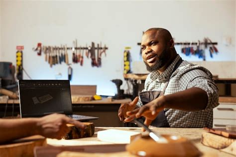 Premium Photo Carpenters Talking Using Program On Notebook To Make Furniture Schematics