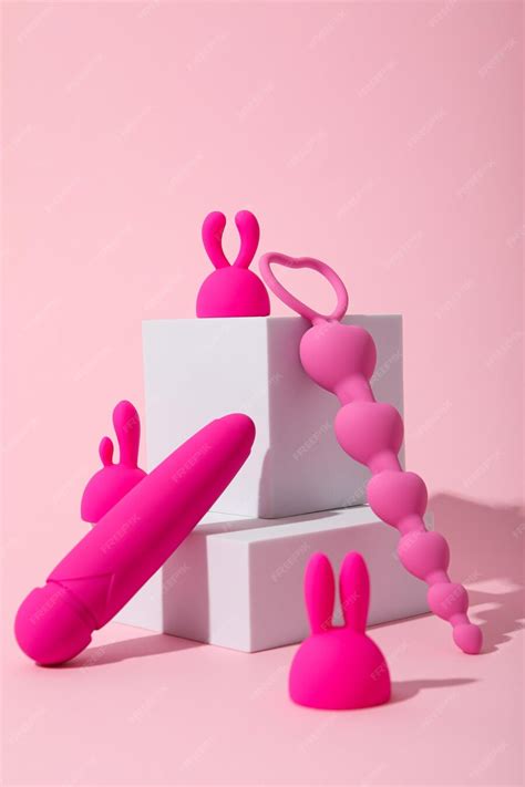 Premium Photo Composition Of Pink Sex Toys With Cubes On A Pink Background