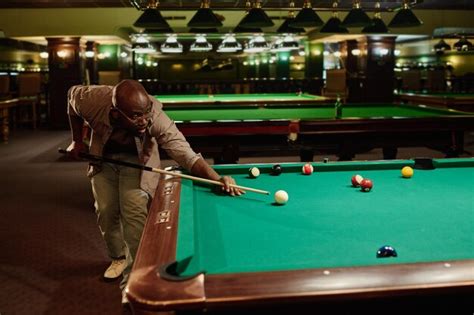 Premium Photo Bending Over Table With Billiard Balls