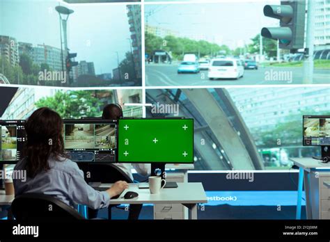 Agency Worker Using Real Time Cctv Footage And Mockup Screen Monitoring Traffic Through