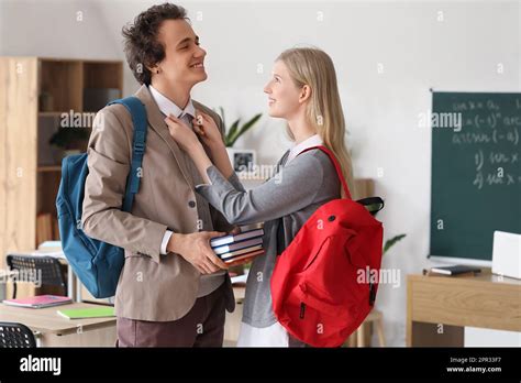 Teenage Girl Fixing Her Babefriend S Collar In Classroom Stock Photo Alamy