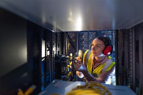 Premium Photo Caucasian Female Engineer Using Smartphone Flash While Inspecting The Server In