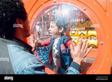 Young Latino Father And Son Happy Playing Among Plastic Games In