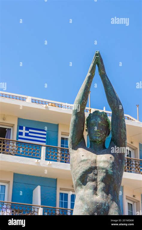 Statue Of A Naked Diver Along The Waterfront Of Pothia Town On The Sponge Fishing Island Of