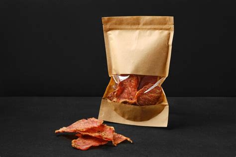 Premium Photo Portion Of Spicy Jerky Pork Meat In Paper Package