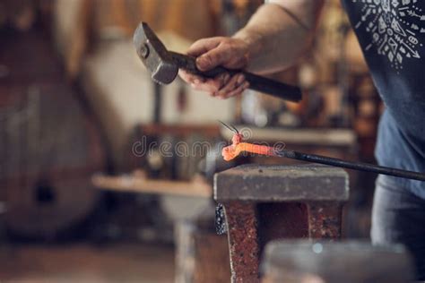 Blacksmith Manually Forging On Iron On Anvil At Forge Treatment Of
