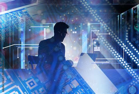 Man Programmer Silhouette System Administrator In Server Room Programmer Sits At Table With