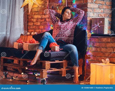 Brunette Female In A Room With Christmas Decoration Stock Photo