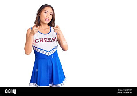 Young Beautiful Chinese Girl Wearing Cheerleader Uniform Pointing
