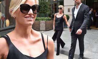 Jessica Simpson Cant Keep Her Skimpy Tank Top In Place As She Holds