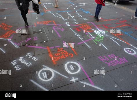 Multi Coloured Utility Markings Painted On A Slate Coloured Pavement