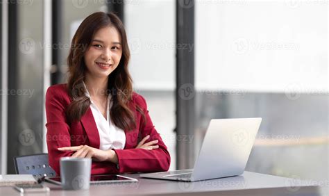 Portrait Of Smiling Beautiful Business Asian Woman In Pink Suit Working