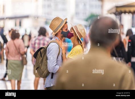 Beautiful Couple Wearing Protective Face Masks And Kissing During Covid