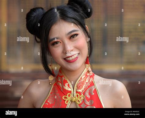 Young Thai Chinese Beauty With Chun Li Double Hair Buns Wears A Stylish