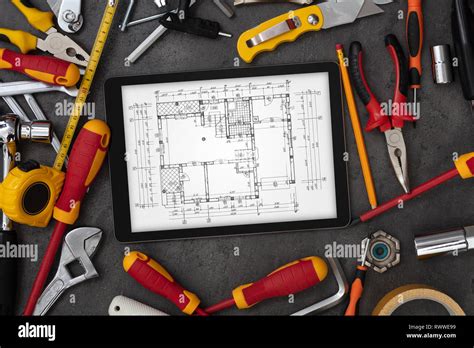 Tablet With Construction Tools And Blueprint Concept Stock Photo Alamy