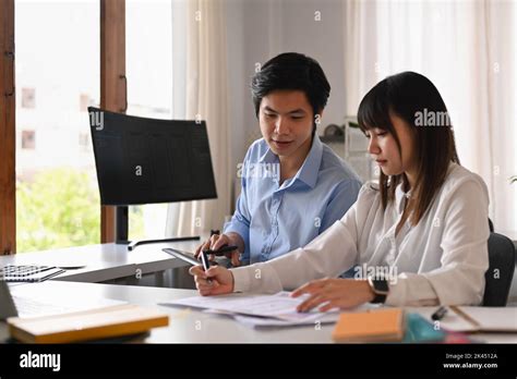 Young Creative People Collaborating On Mobile Application Software Design Project At Modern Co