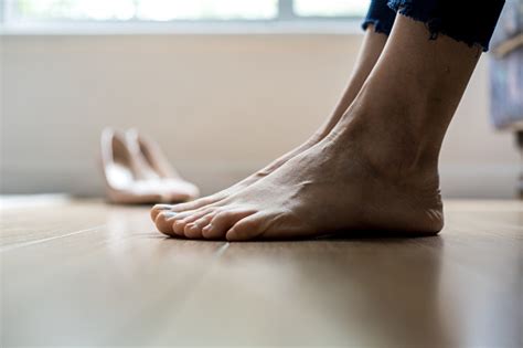 Barefoot Woman Focus On Feet And Shoes In Blur Symbolic Image Resting