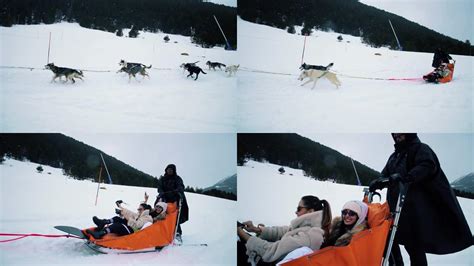 雪山上的狗拉雪橇，女人坐在雪橇上。与雪4k一起奔跑的哈士奇视图视频素材下载