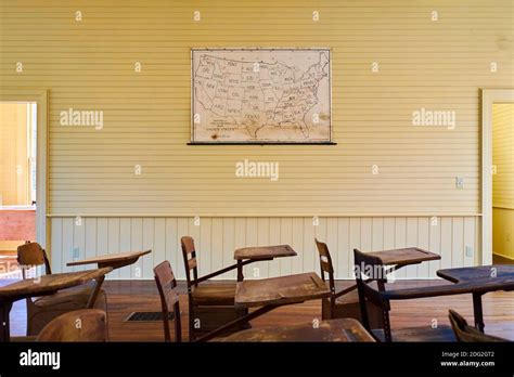 One Of The Original Old Classrooms With Wooden Desks And Wall Map At
