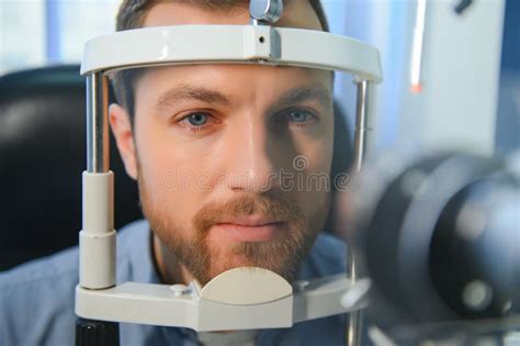 Adult Man Eyesight Test With Binocular Slit Lamp Checking Retina Of A