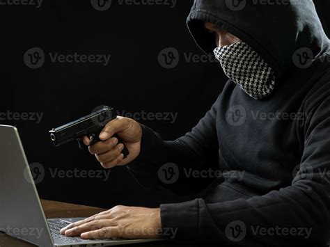 Hacker Spy Man One Person In Black Hoodie Sitting On A Table Looking