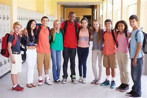 Group High School Students Wearing Uniform Running Out School Buildings